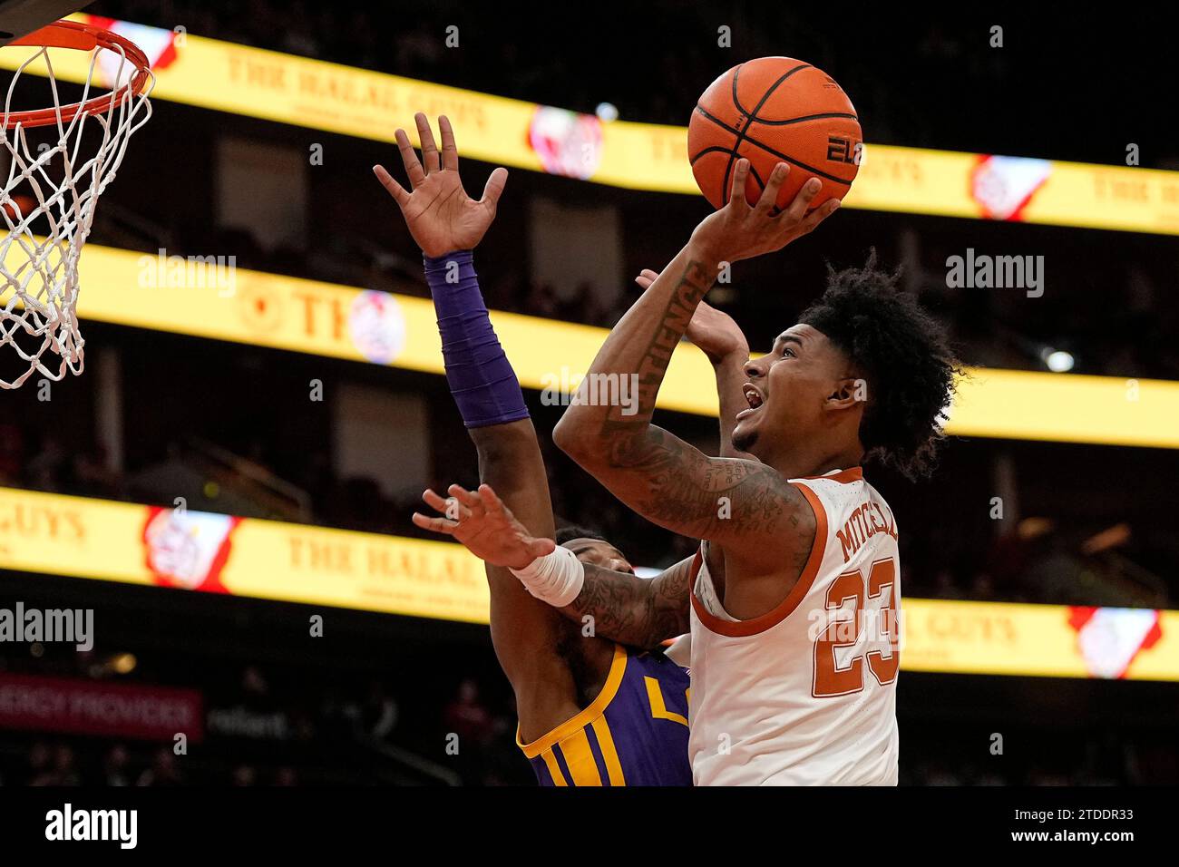 Texas forward Dillon Mitchell (23) scores over LSU guard Jordan Wright ...