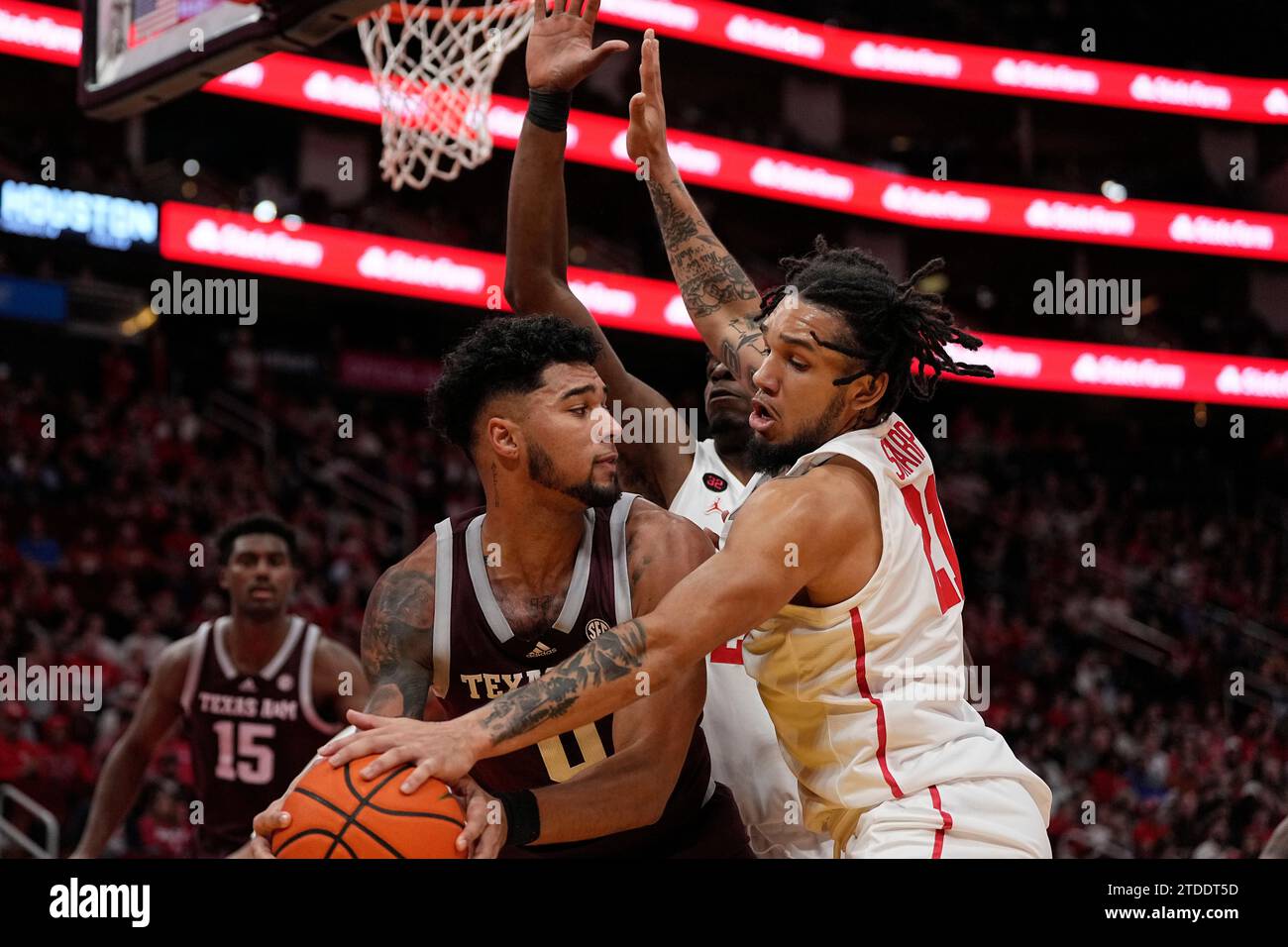 Texas A&M guard Jace Carter (0) is defended by Houston guard Emanuel ...