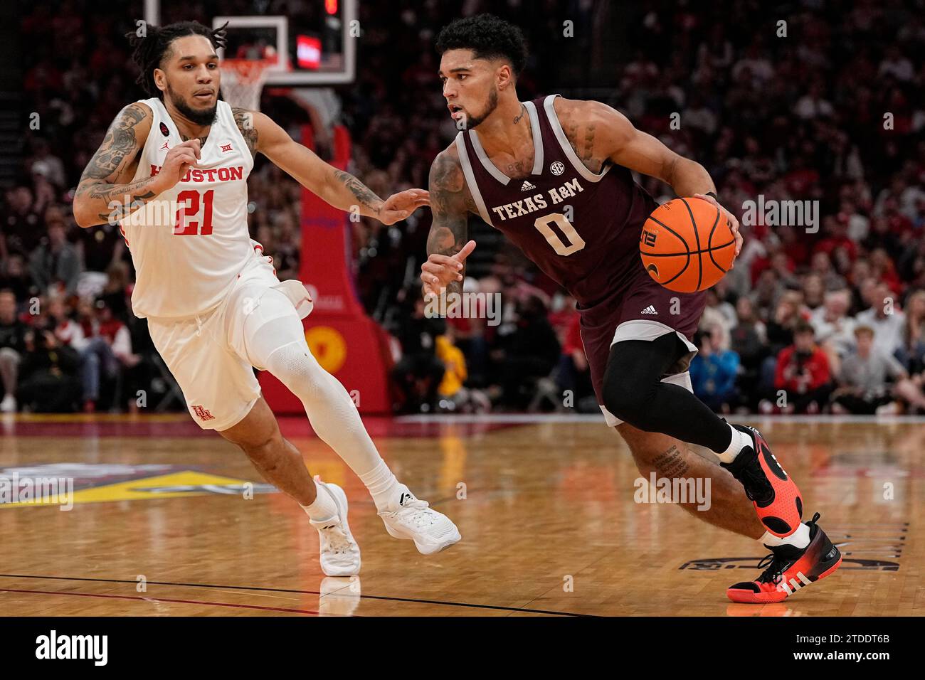 Texas A&M guard Jace Carter (0) drives around Houston guard Emanuel ...