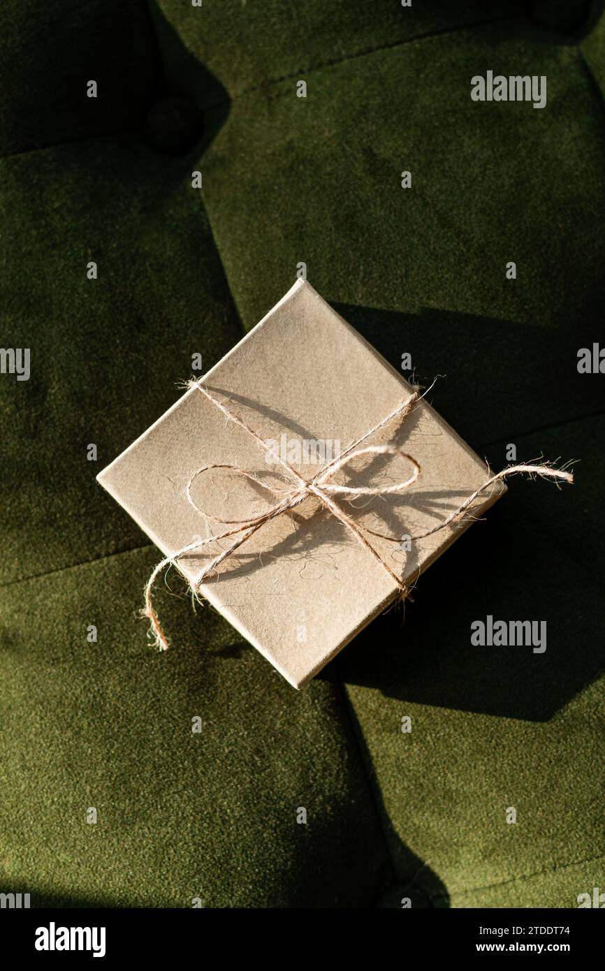 Small kraft gift box tied with string with dark background Stock Photo ...