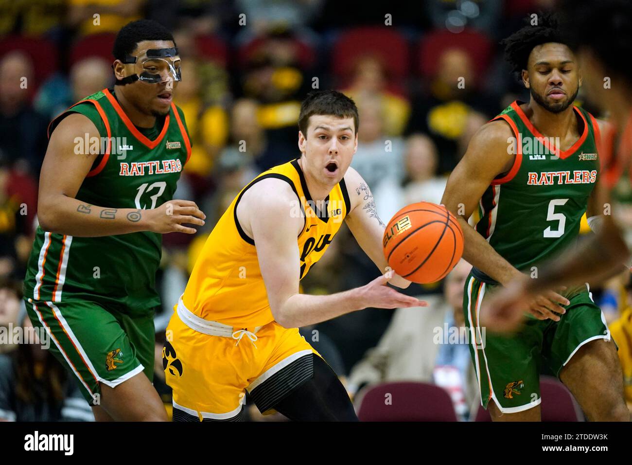 Iowa forward Patrick McCaffery, center, drives up court in front of ...