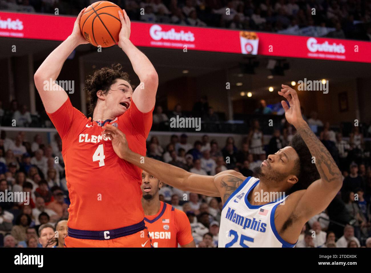 Clemson forward Ian Schieffelin (4) grabs a rebound defended by Memphis ...