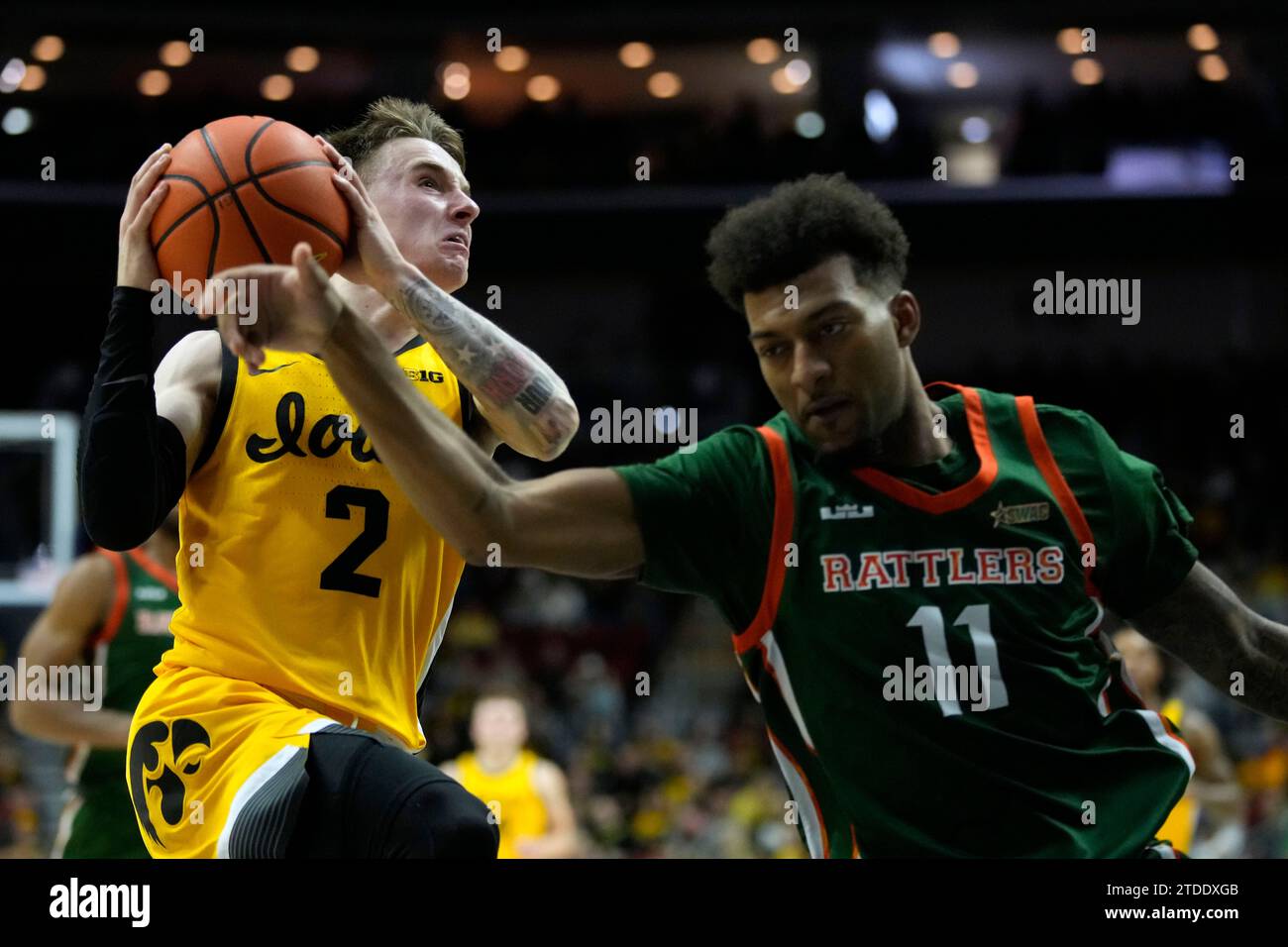 Iowa guard Brock Harding (2) drives to the basket in front of Florida A ...