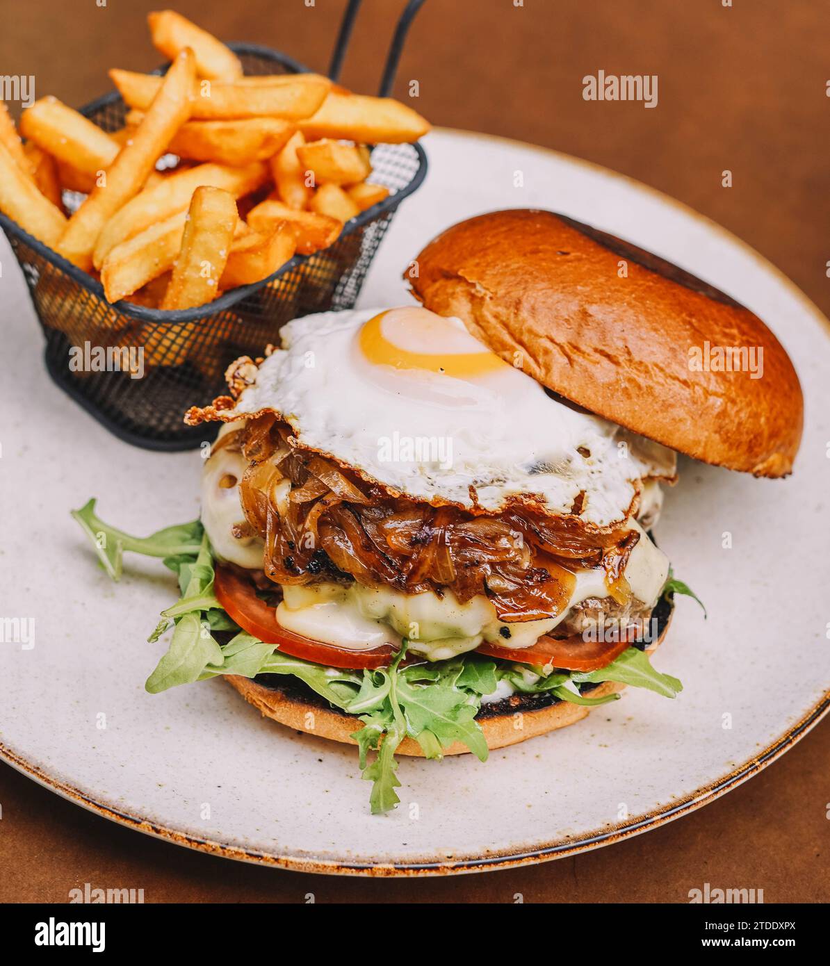 Full rustic beef burger with fries and fried egg Stock Photo - Alamy