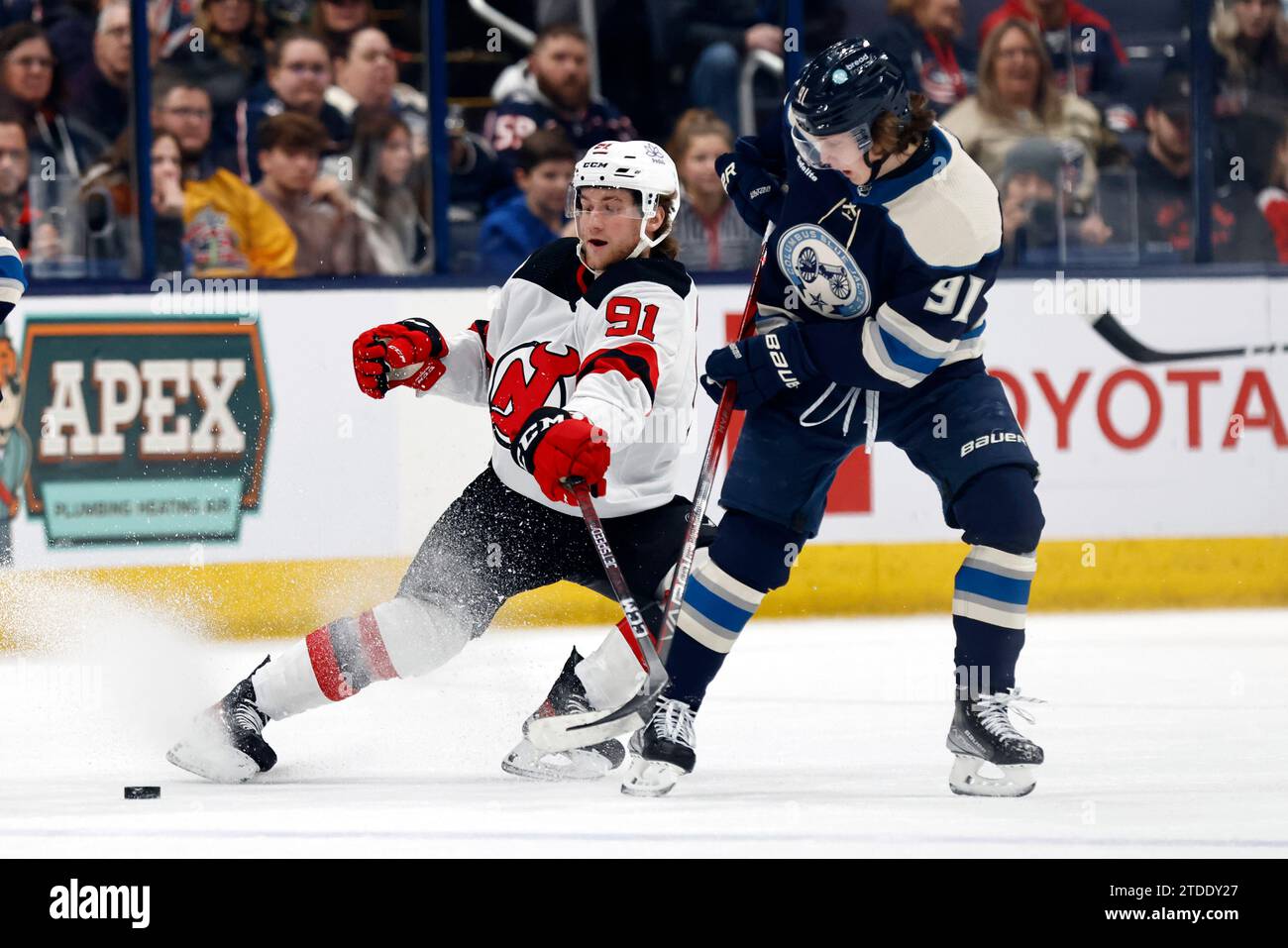 New Jersey Devils forward Dawson Mercer, left, reaches for the puck in ...