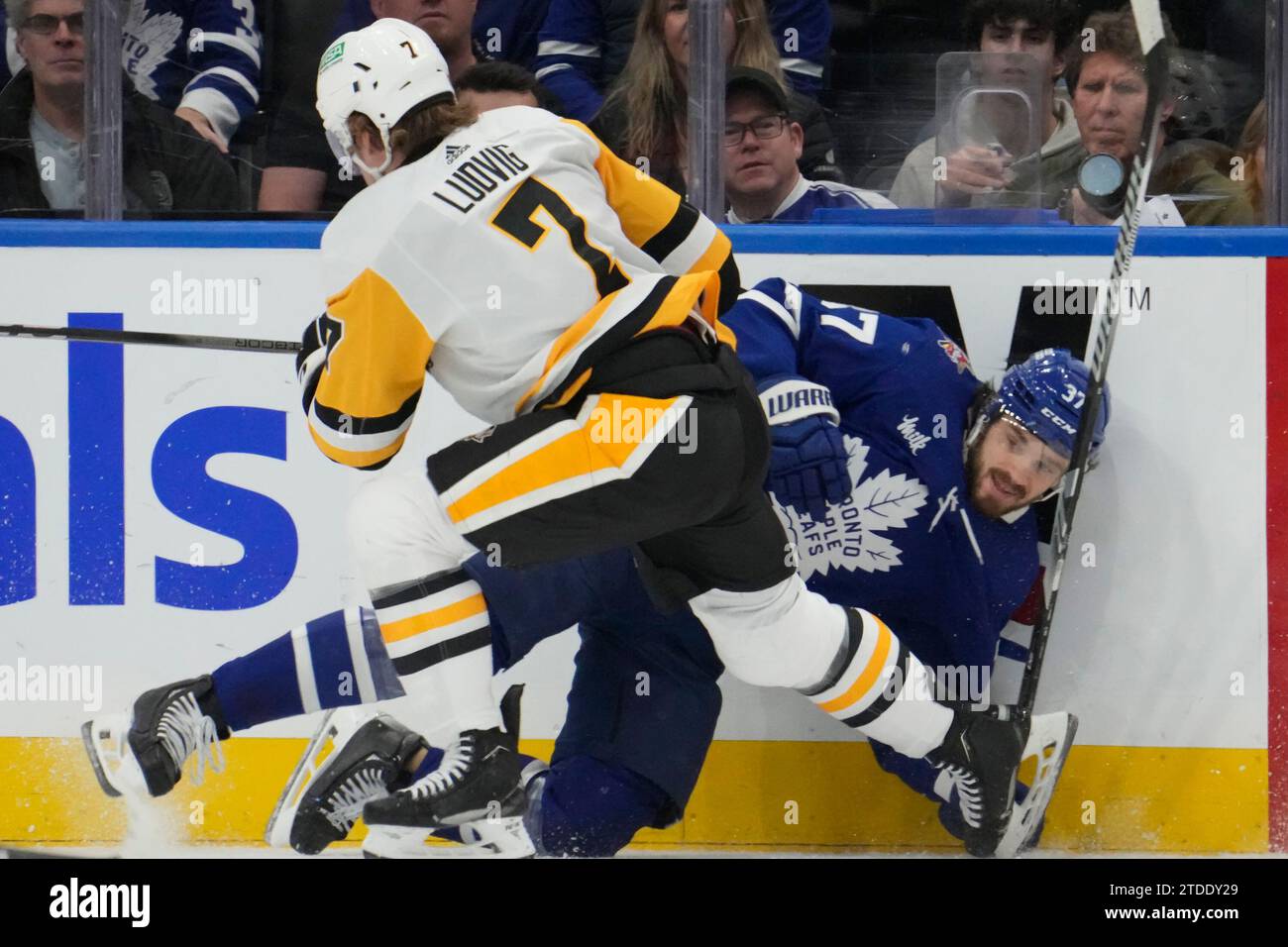 Pittsburgh Penguins' John Ludvig checks Toronto Maple Leafs defenseman ...