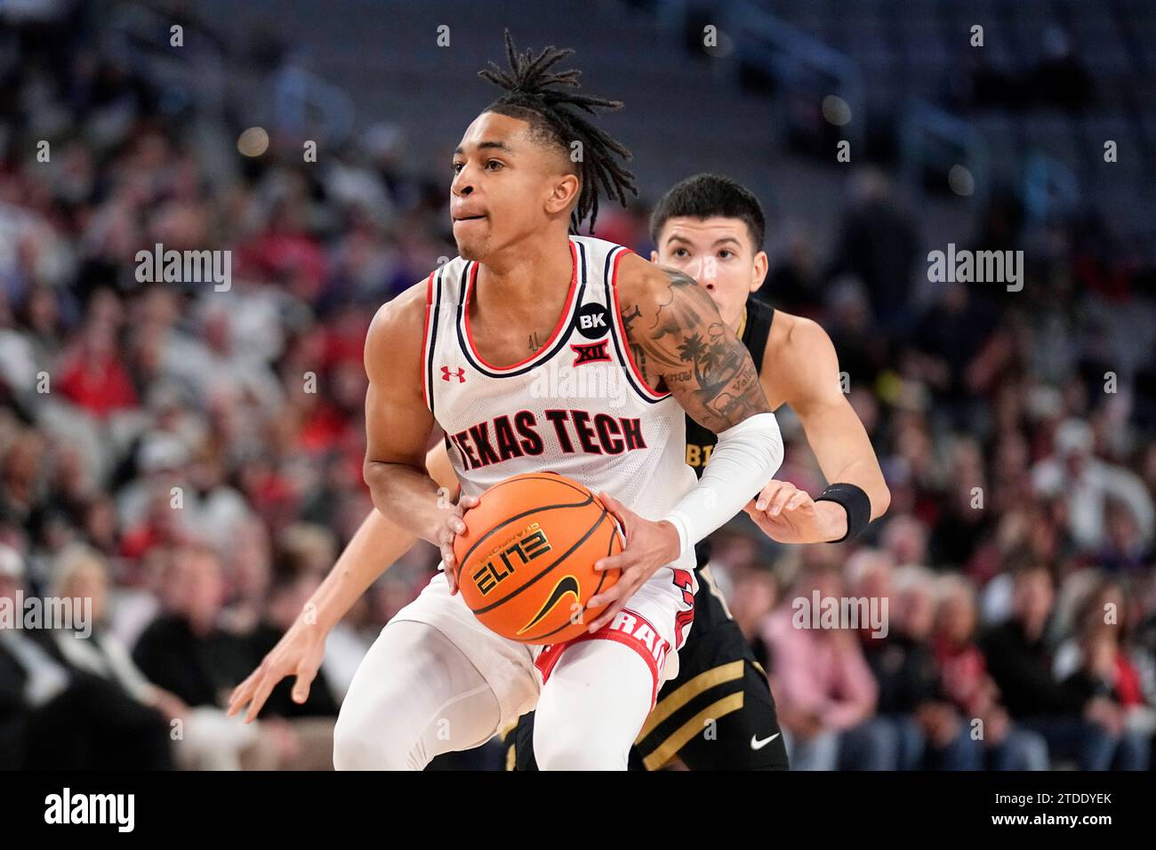 Texas Tech guard Chance McMillian, left, drives past Vanderbilt guard ...