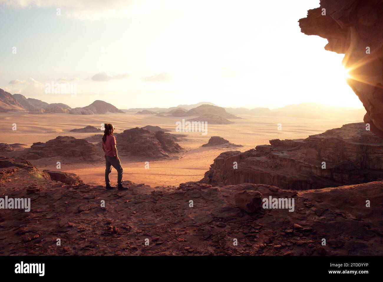One man looking at view of desert during sunset in Wadi Rum Stock Photo ...