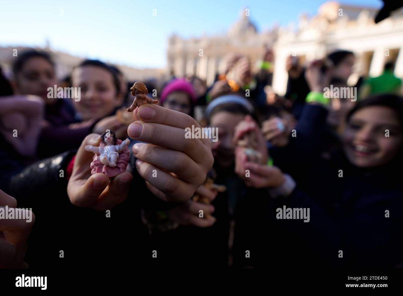 Children hold up statues of baby Jesus as they wait for Pope Francis ...