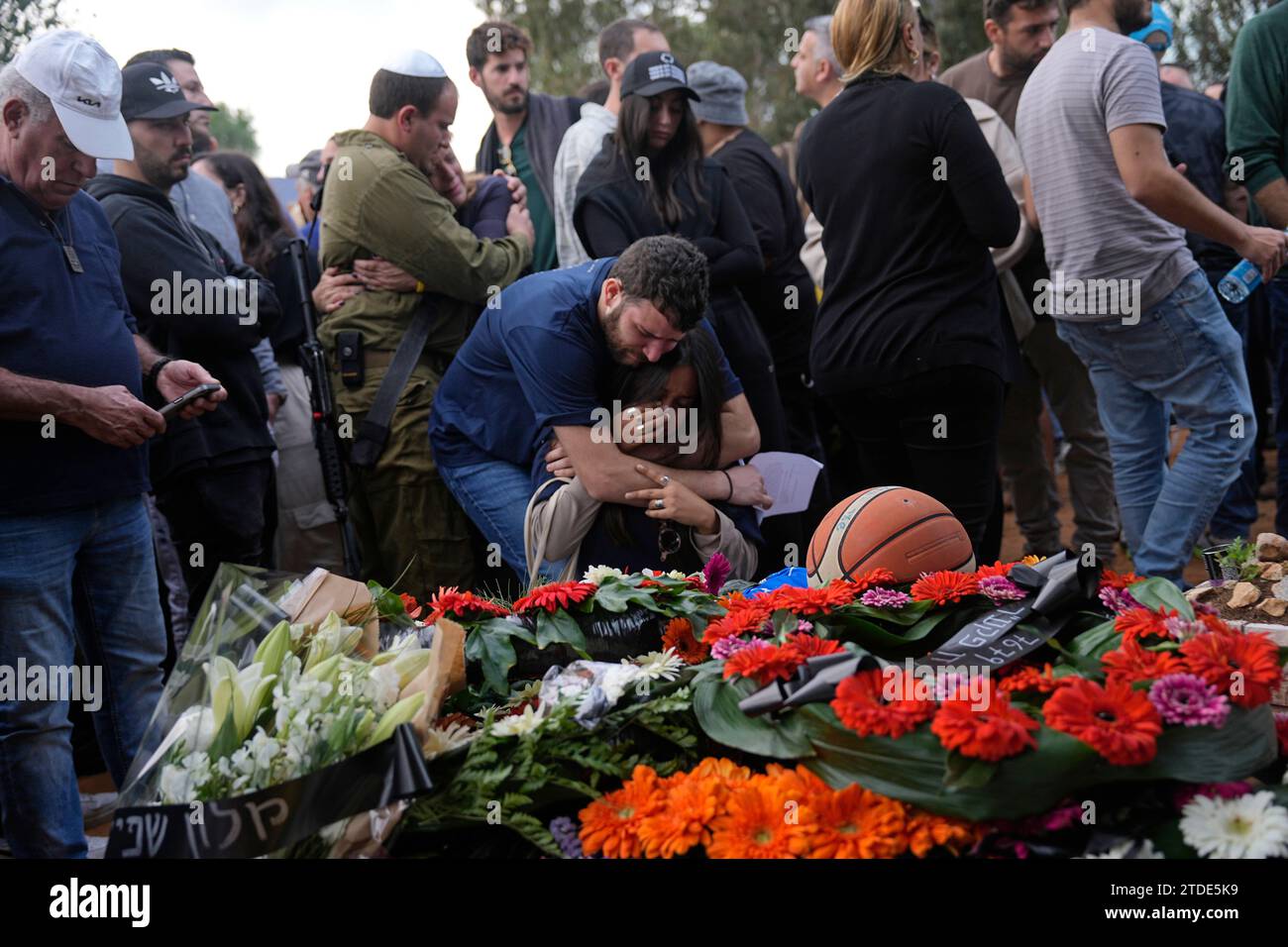 Family and friends of Alon Shamriz, 26, mourn over his grave during his ...