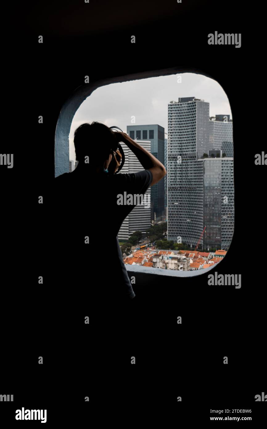 Young Photographer Frames Cityscape Through Window Stock Photo - Alamy