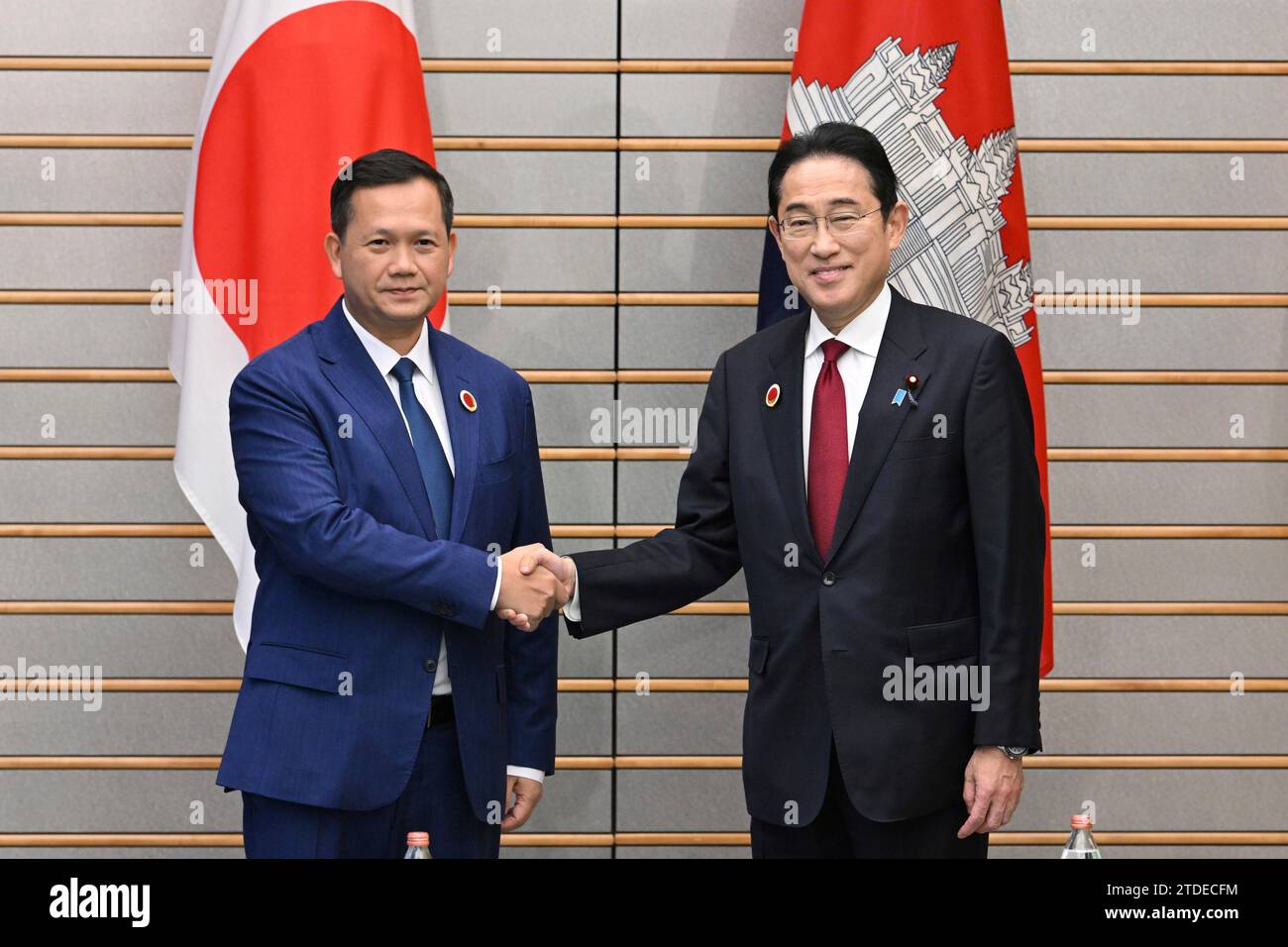 Japan's Prime Minister Fumio Kishida, right, shakes hands with Cambodia ...