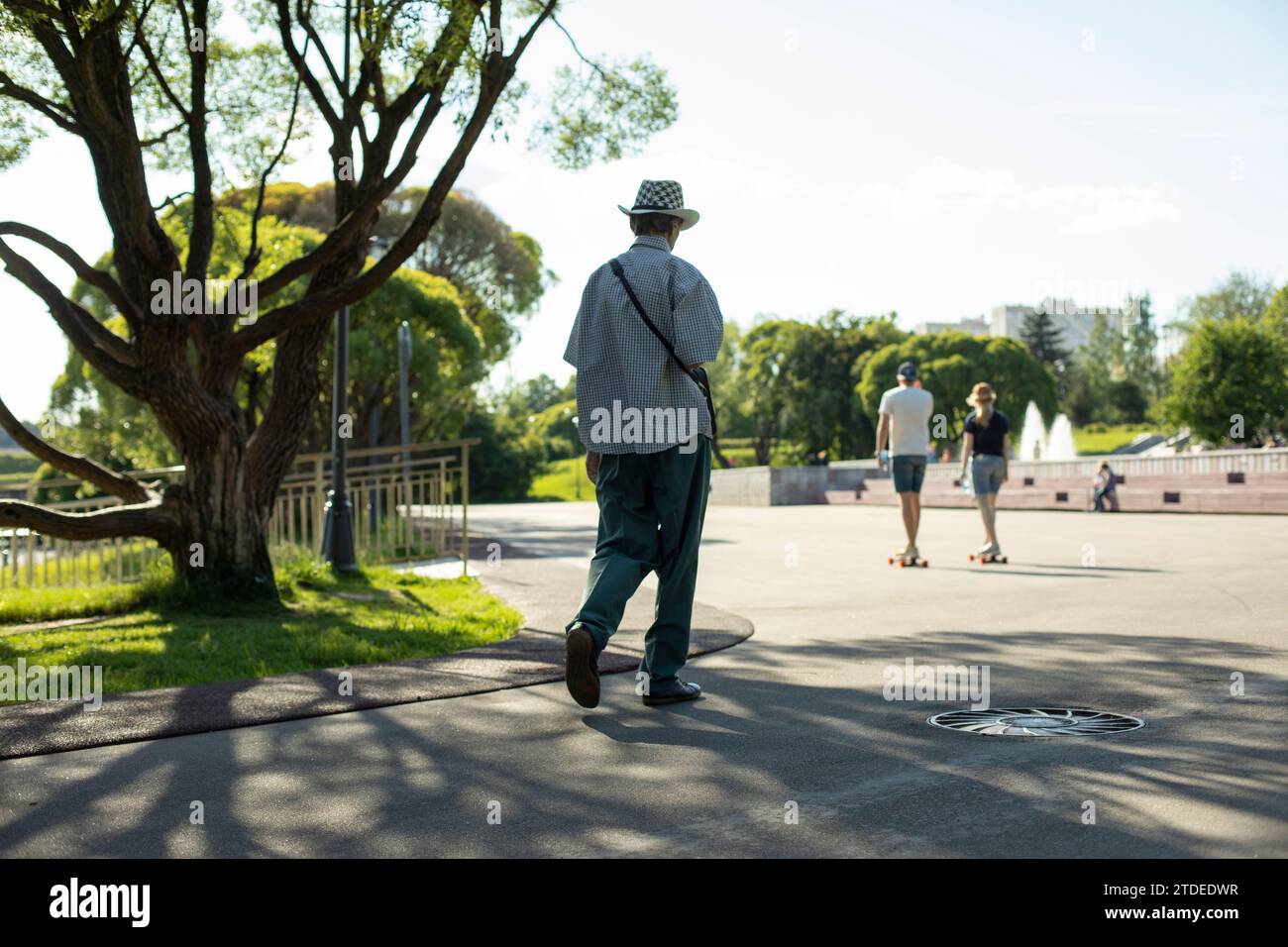 Guy walks through park in summer. Walking around city on summer day ...