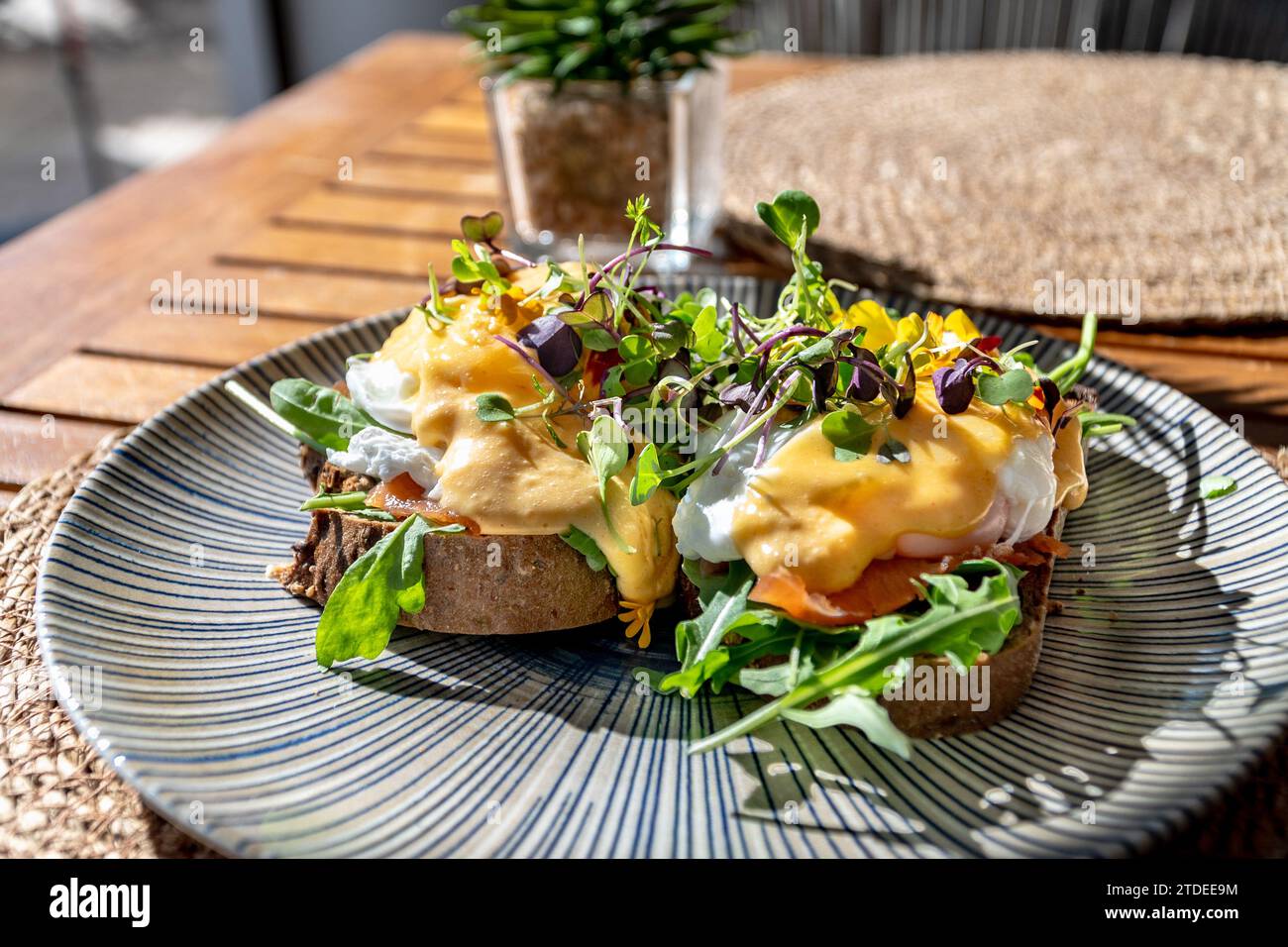 a close up image of grilled toast topped with eggs benedict in a ...
