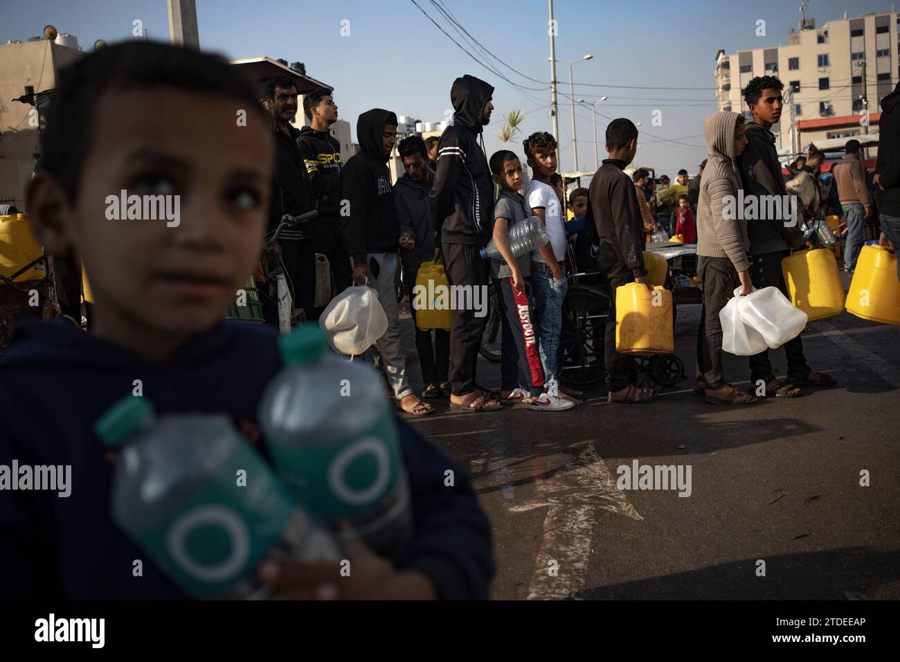Palestinians line up for water in the Muwasi area in the south of the ...