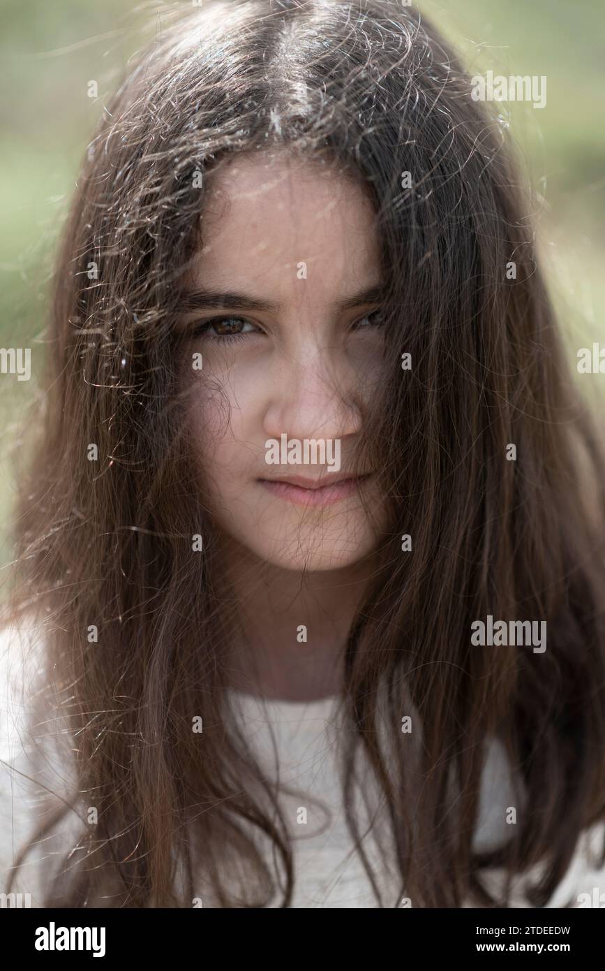 Serious girl hair covering face staring Stock Photo - Alamy