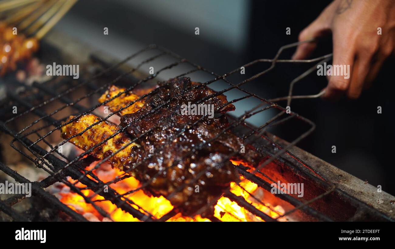 Close up of grilling process on a large size beef ribs on traditional ...