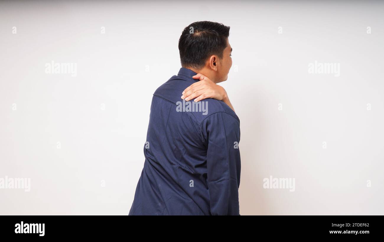 Gesture of young asian man suffering back pain on white background ...