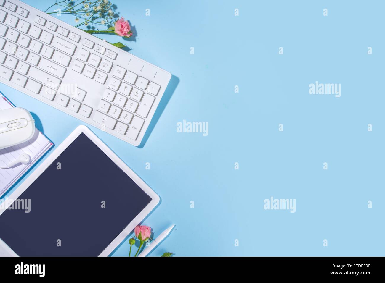 Spring office desk flatlay with keyboard, notepad, tablet, mouse ...
