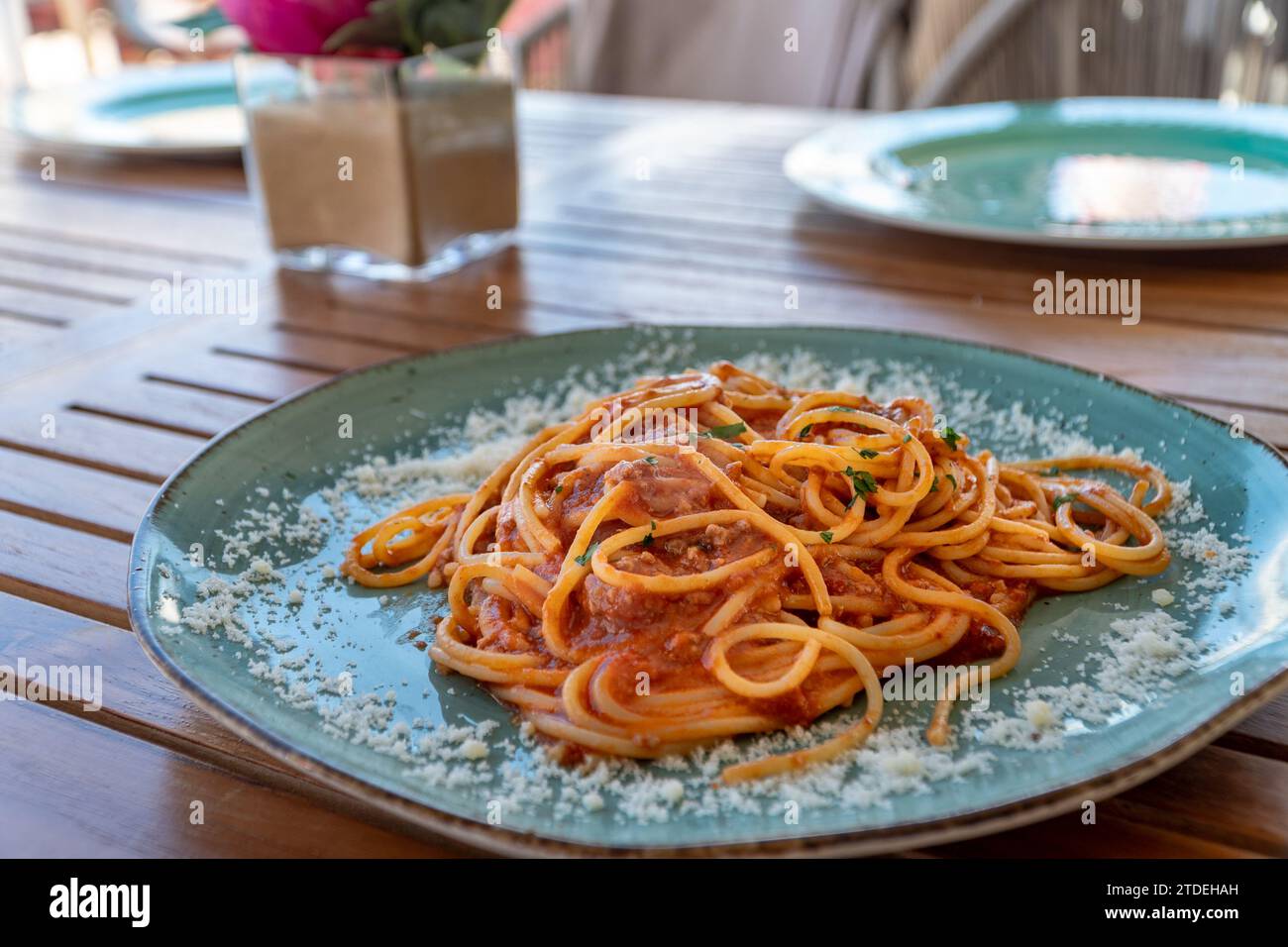 a close up image of a plate of spaghetti Bolognese in a mediterranean ...
