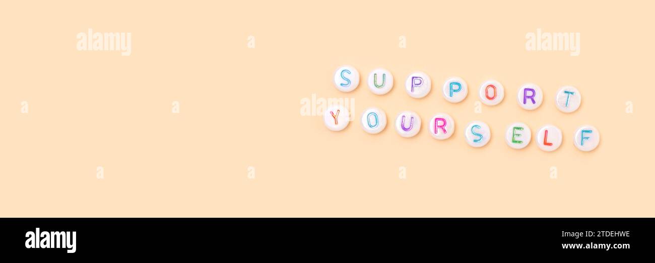Support yourself. Banner with quote made of beads with letters on a ...