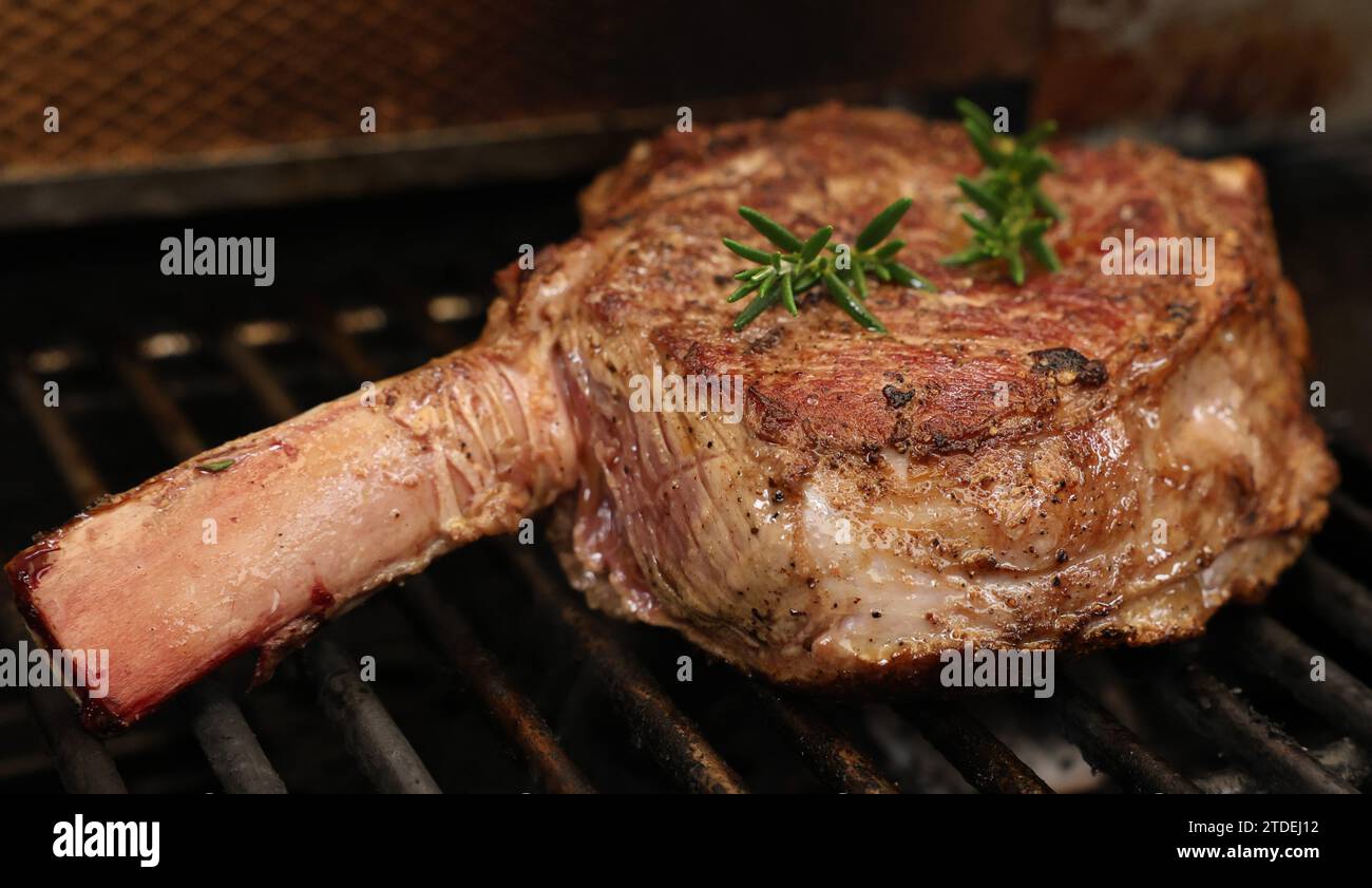 Cooking a rib-eye steak on a grill, griller or bbq. A large rib eye ...