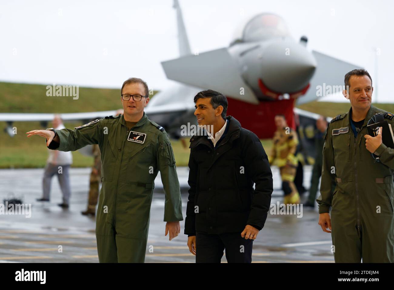 Prime Minister Rishi Sunak (centre) arrives with Group captain Jim Lee ...