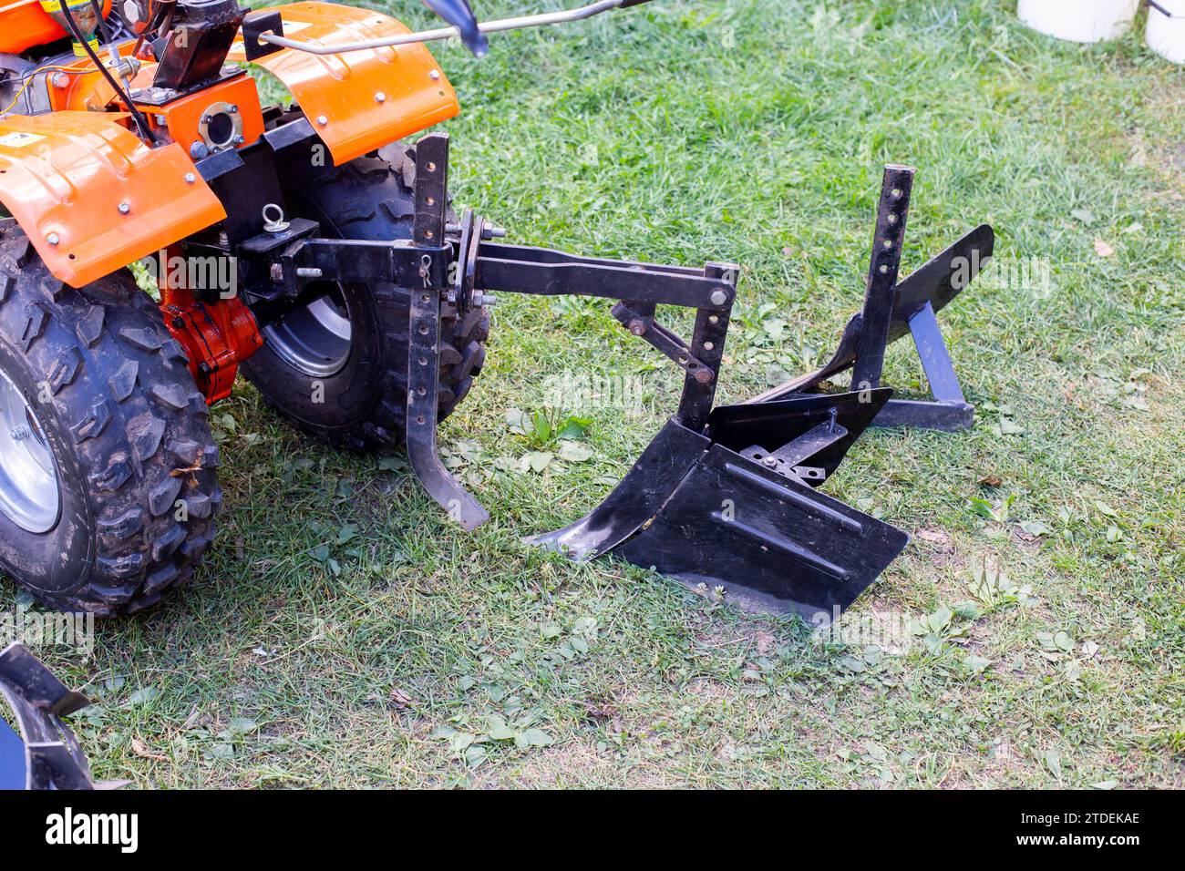 Plow and hiller complete with a walk-behind tractor for agricultural ...