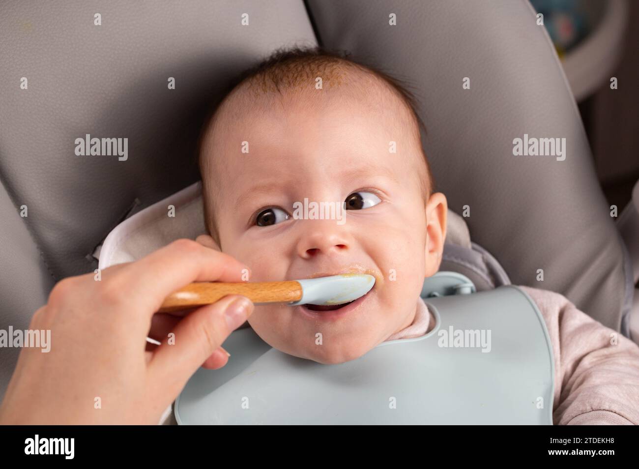 A little boy caucasian has been trying porridge and fruit puree for 6 ...