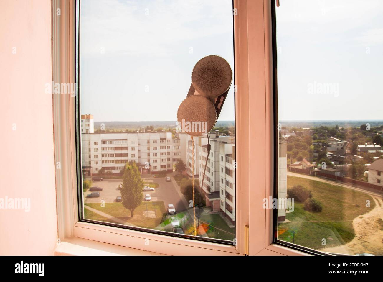 A modern vacuum robot window cleaner washes glass from dirt and stains ...