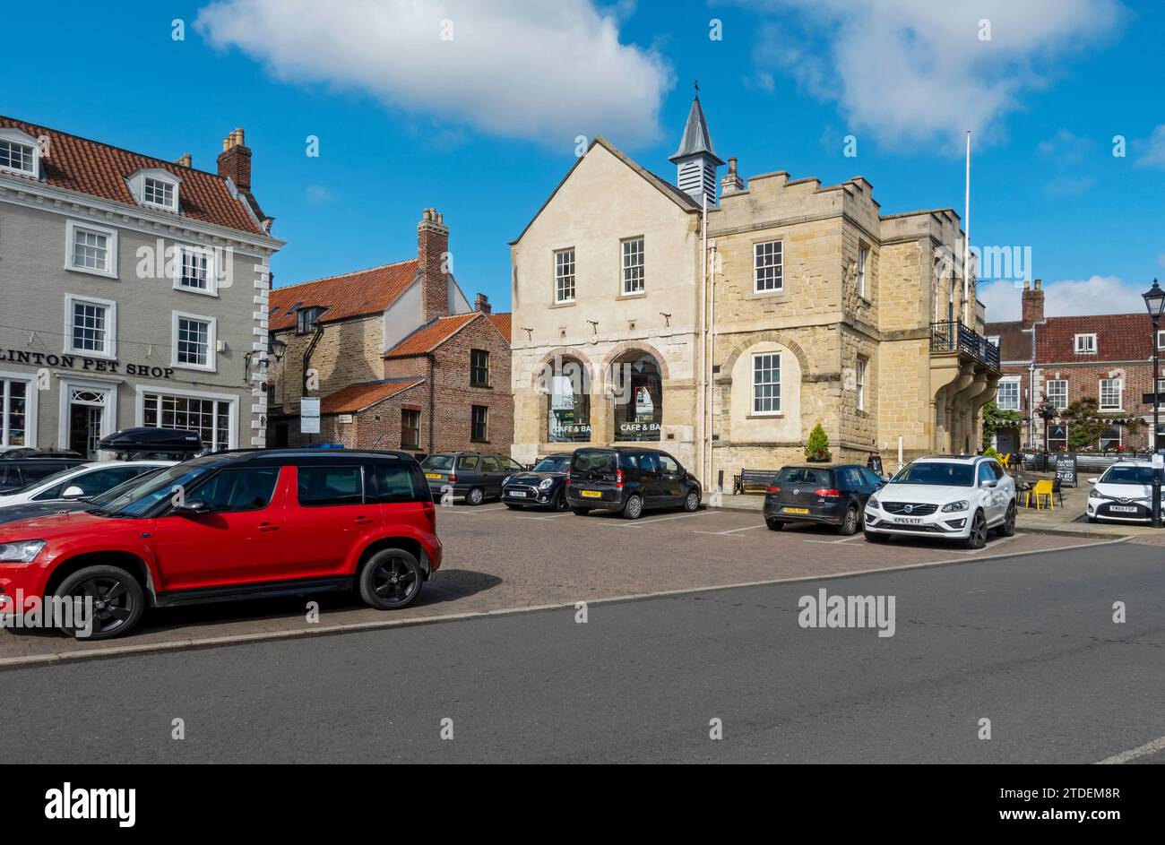 The old Town Hall and cars parked in the street Market Place in summer ...