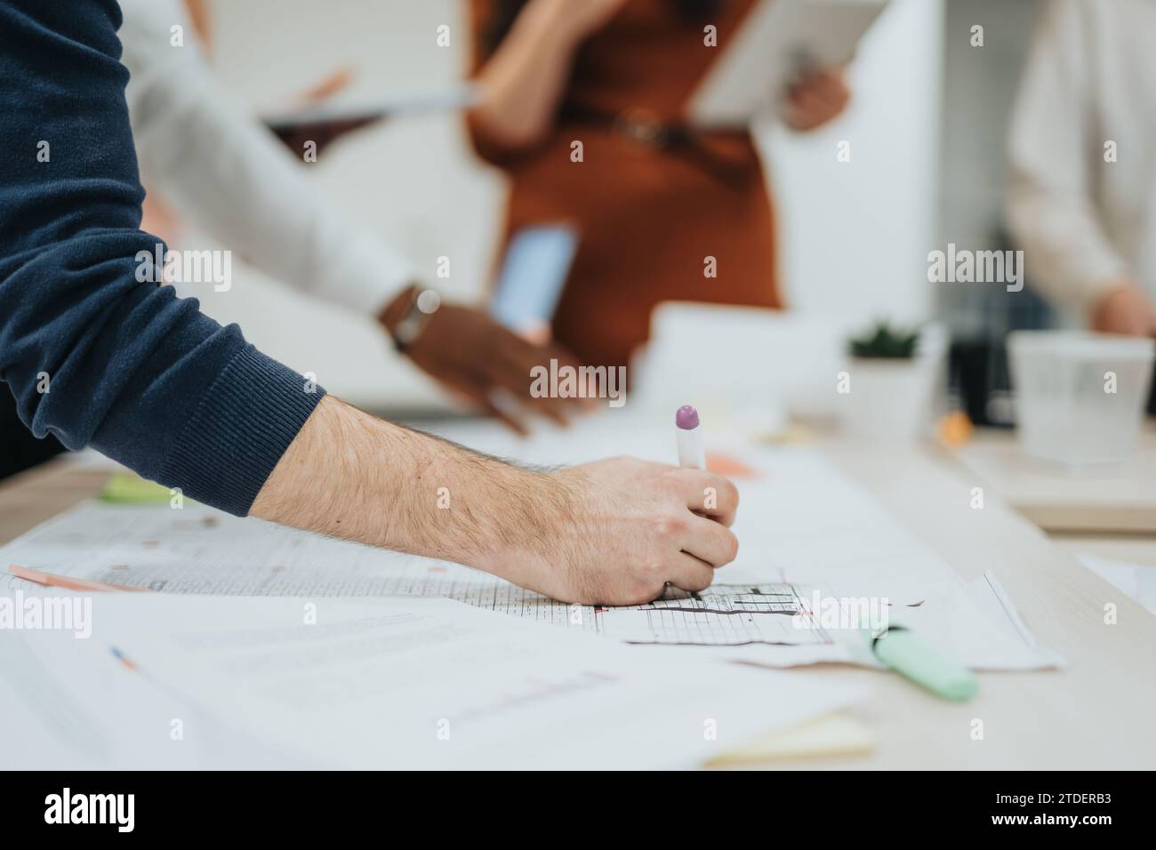 Business team analyzing reports, brainstorming strategies for company ...