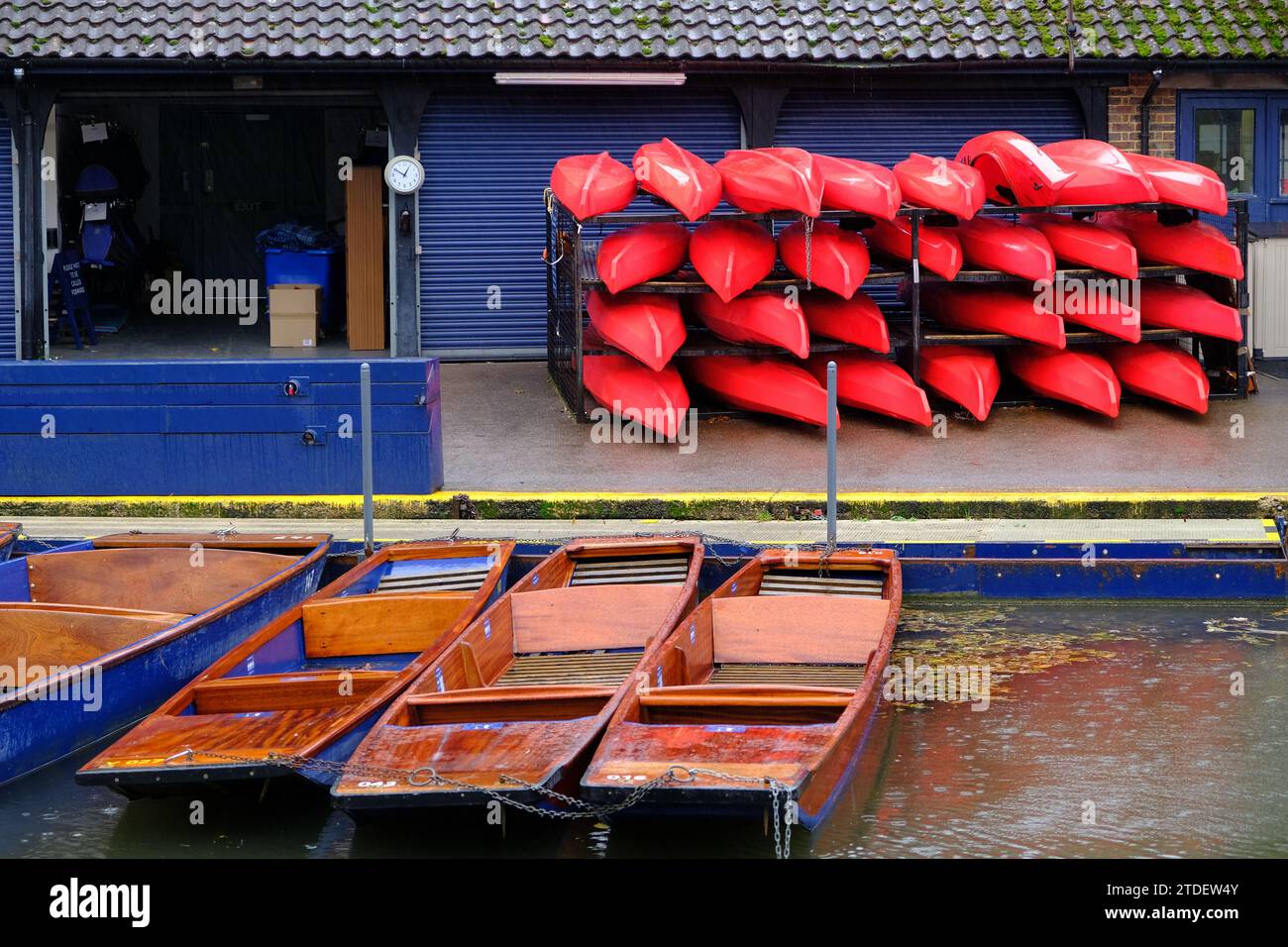 Stacked canoes and punting boats stored in a sports club creating ...