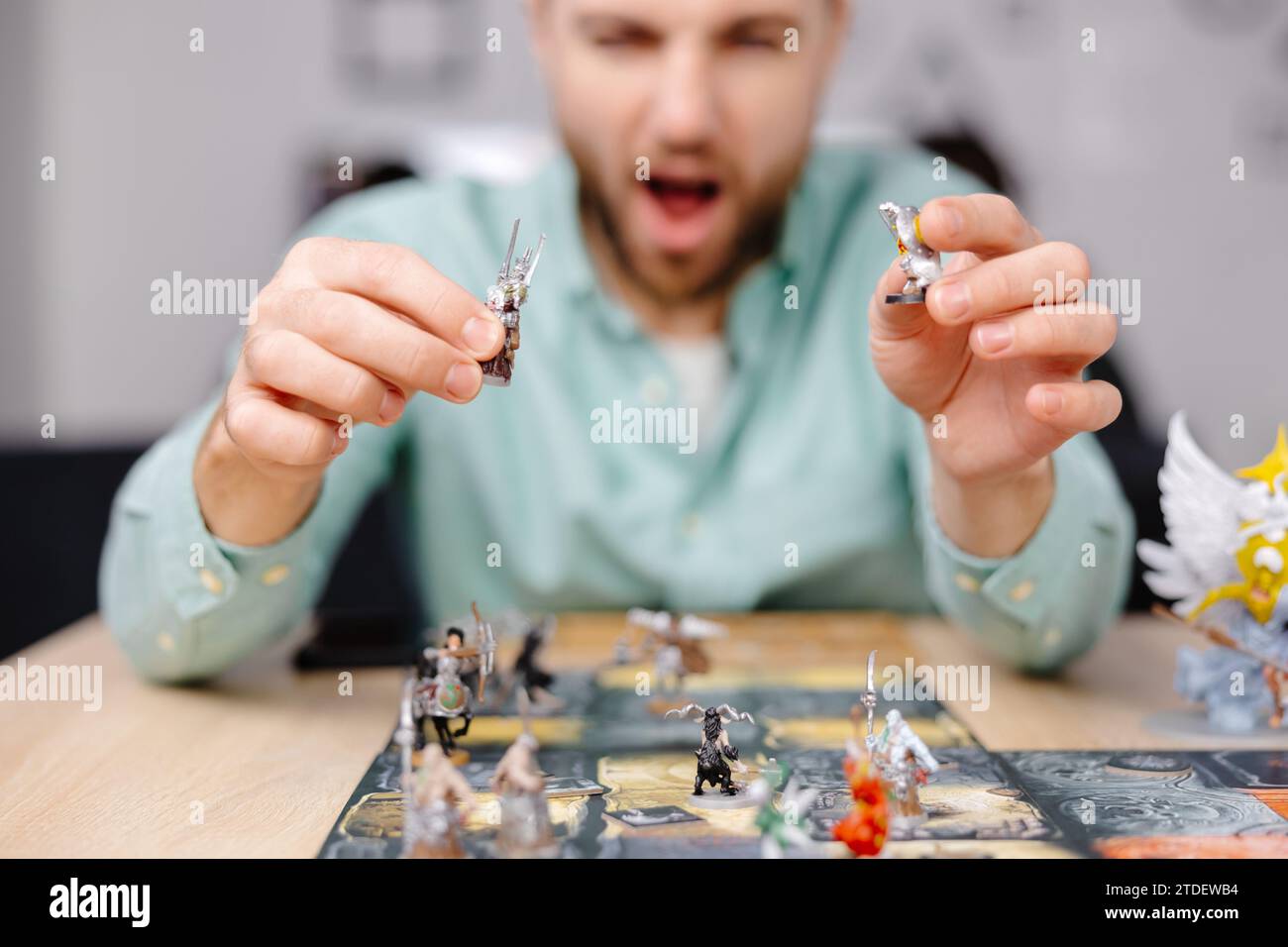 Man with board game piece while practicing strategy in home alone. A ...
