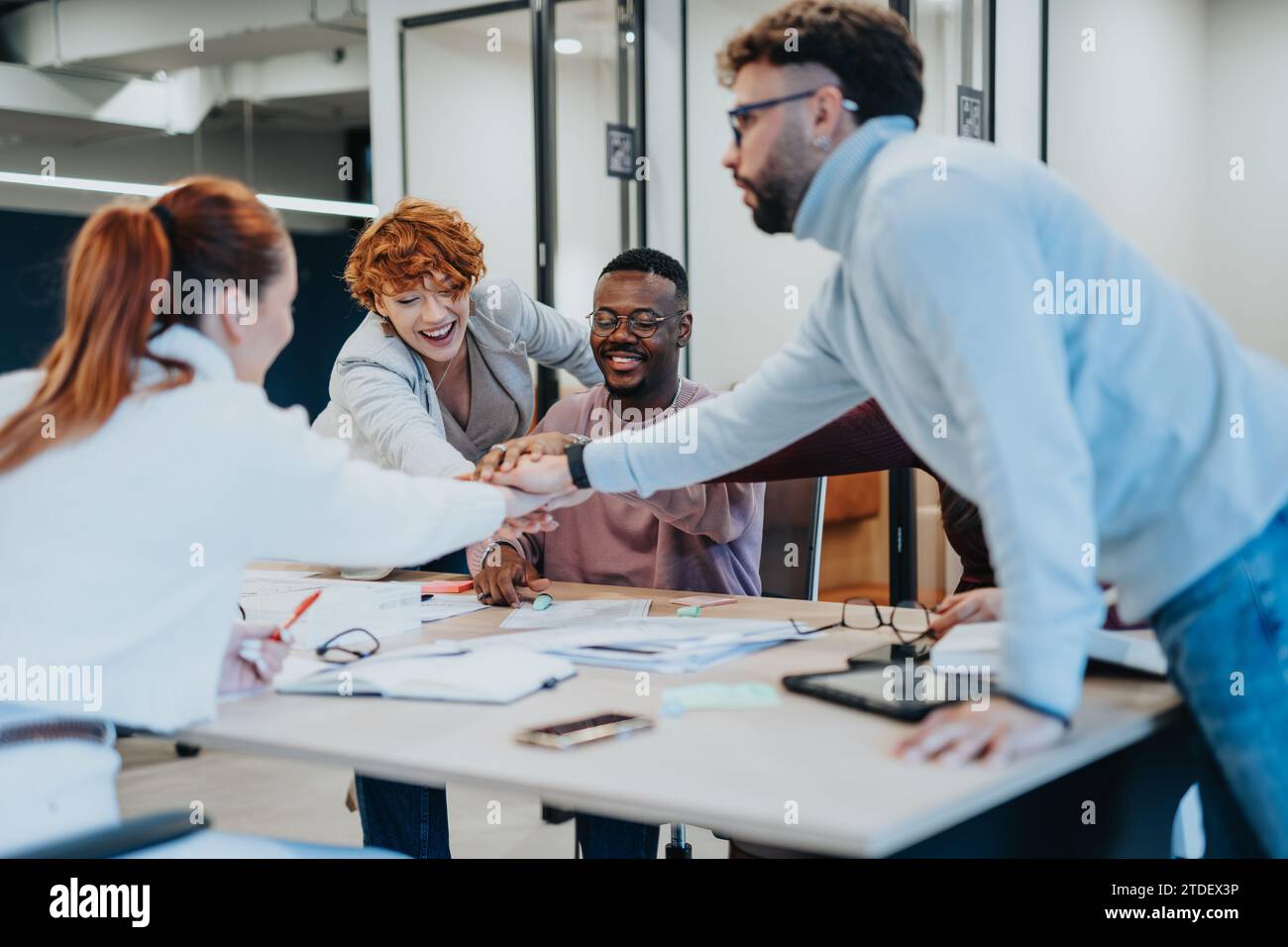 Successful business colleagues celebrating achievements in office ...