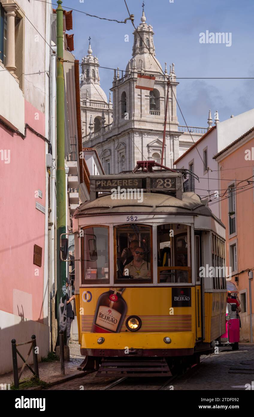 Trams and tourist buggies in the Alfama old town area of Lisbon ...