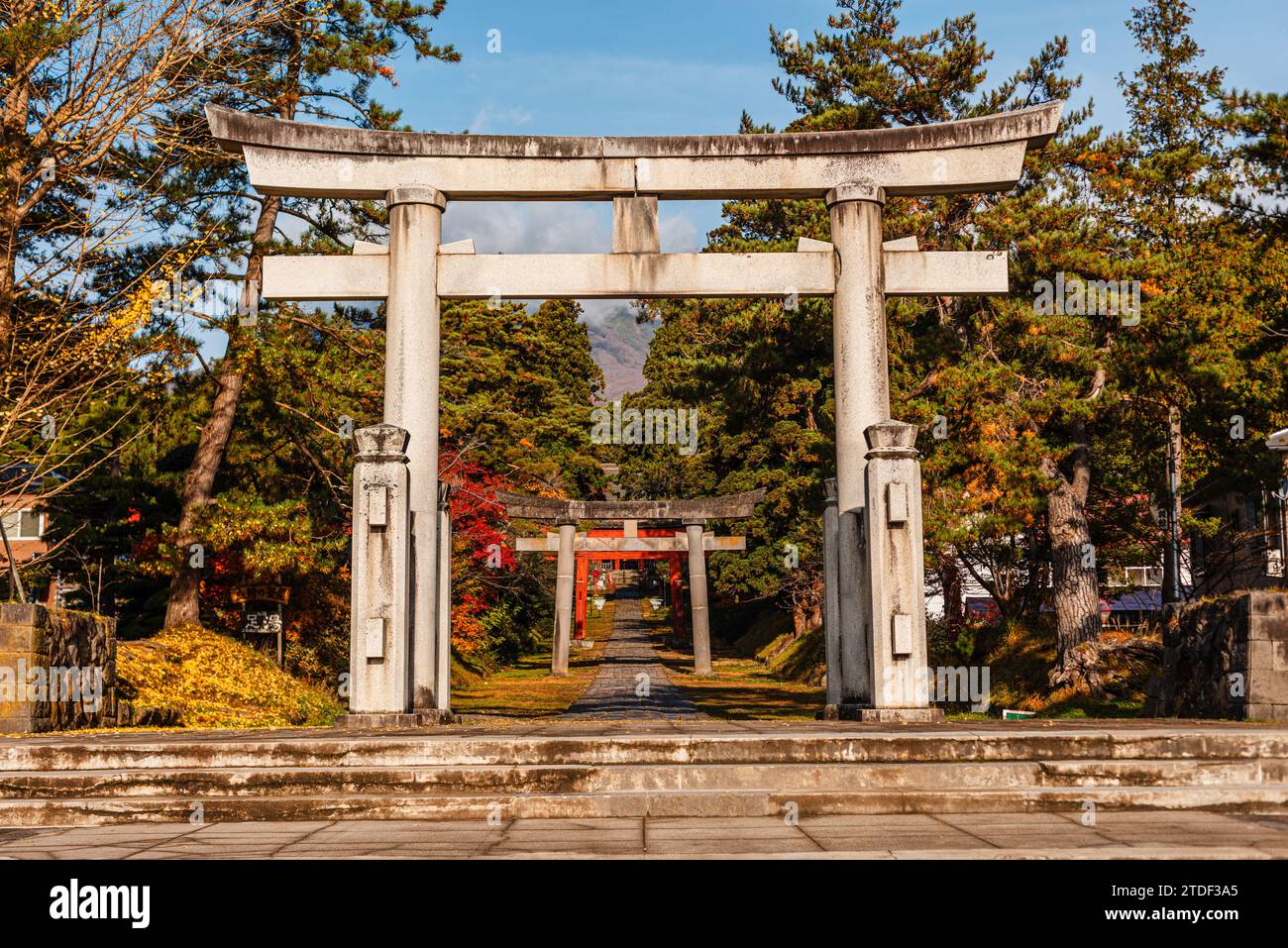 Big stone torii gate framing more distant gates on the foot of mount ...