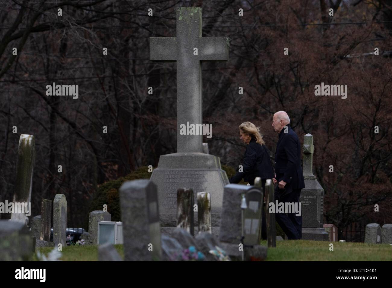 President Joe Biden and first lady Jill Biden, walk between tombstones ...
