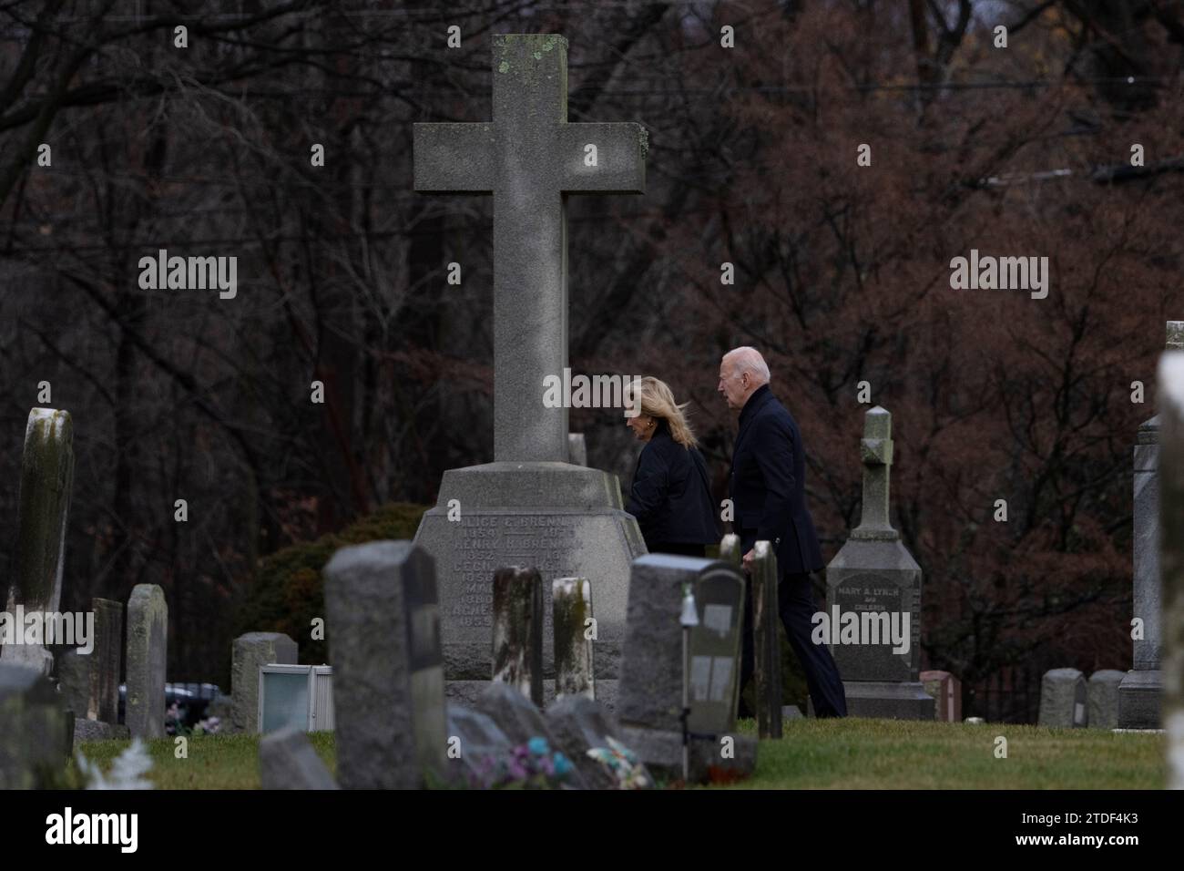 President Joe Biden and first lady Jill Biden, walk between tombstones ...