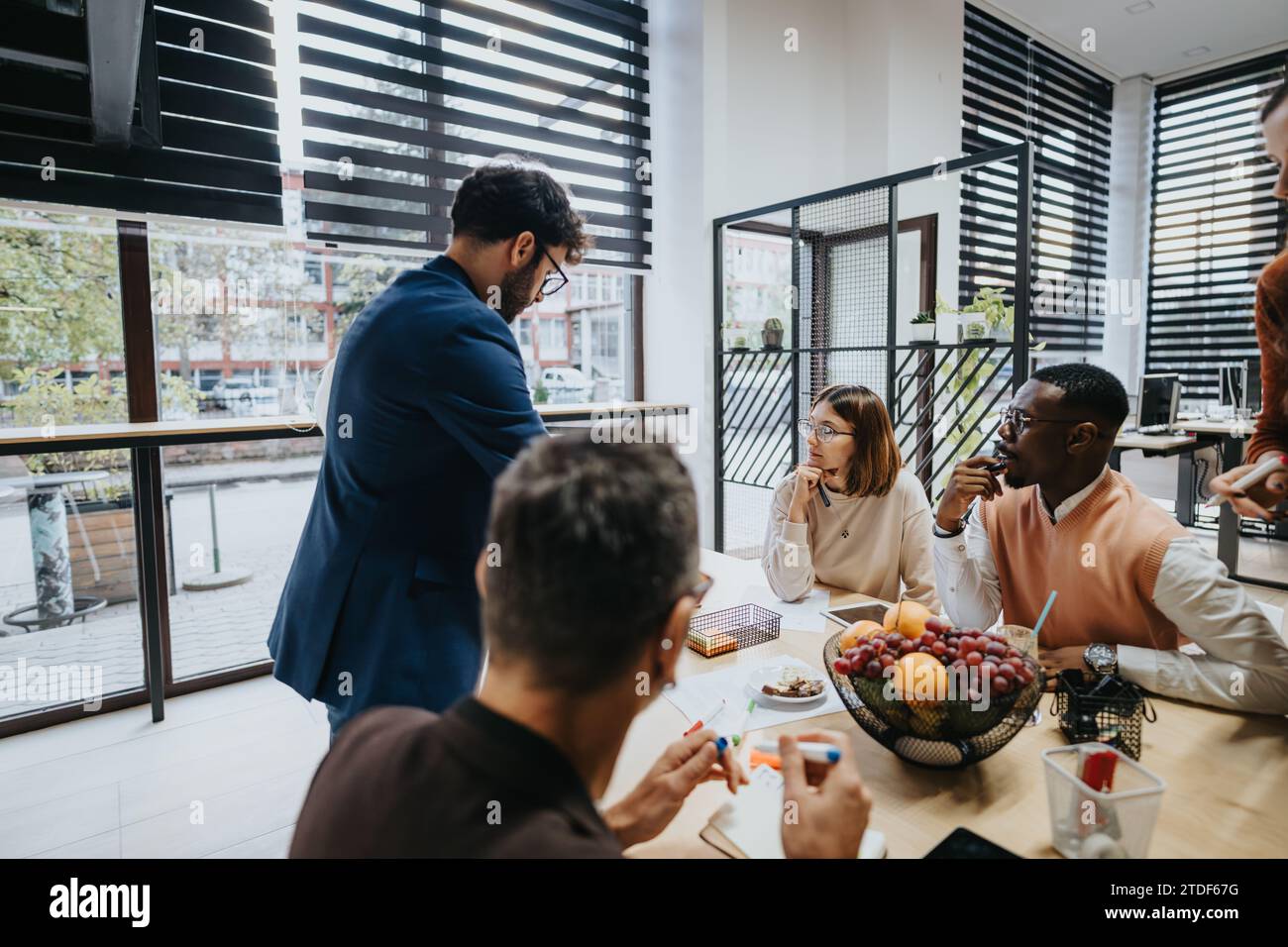 Diverse professionals collaborating, strategizing, and analyzing data ...