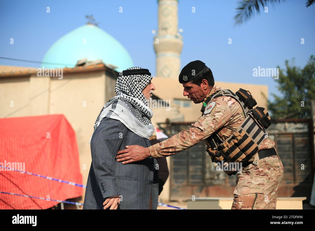 Baghdad, Iraq. 18th Dec, 2023. An Iraqi officer conducts a body search ...