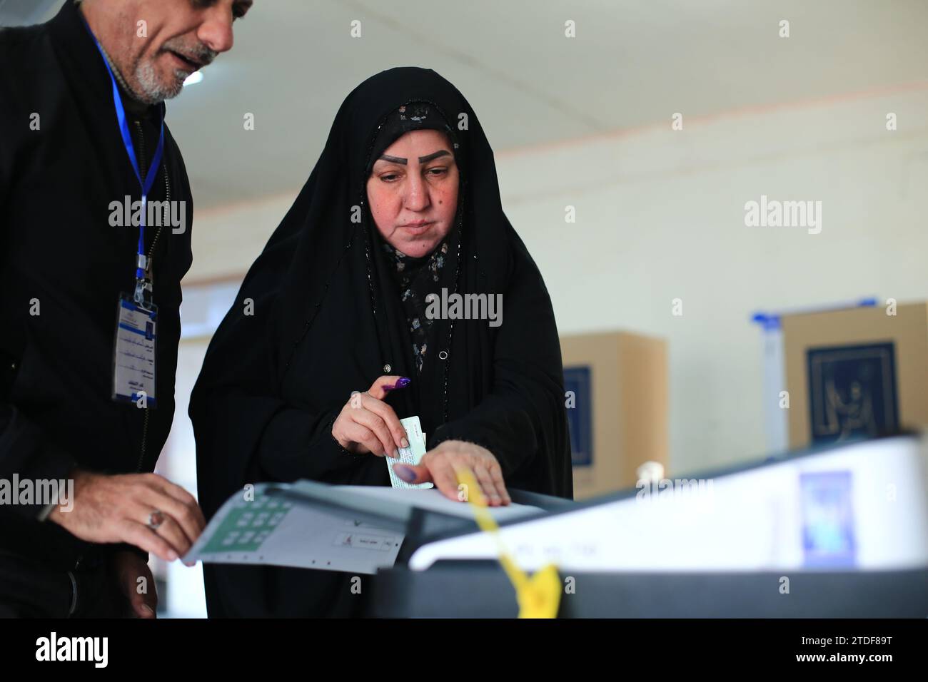 Baghdad, Iraq. 18th Dec, 2023. An Iraqi woman casts her vote in the ...