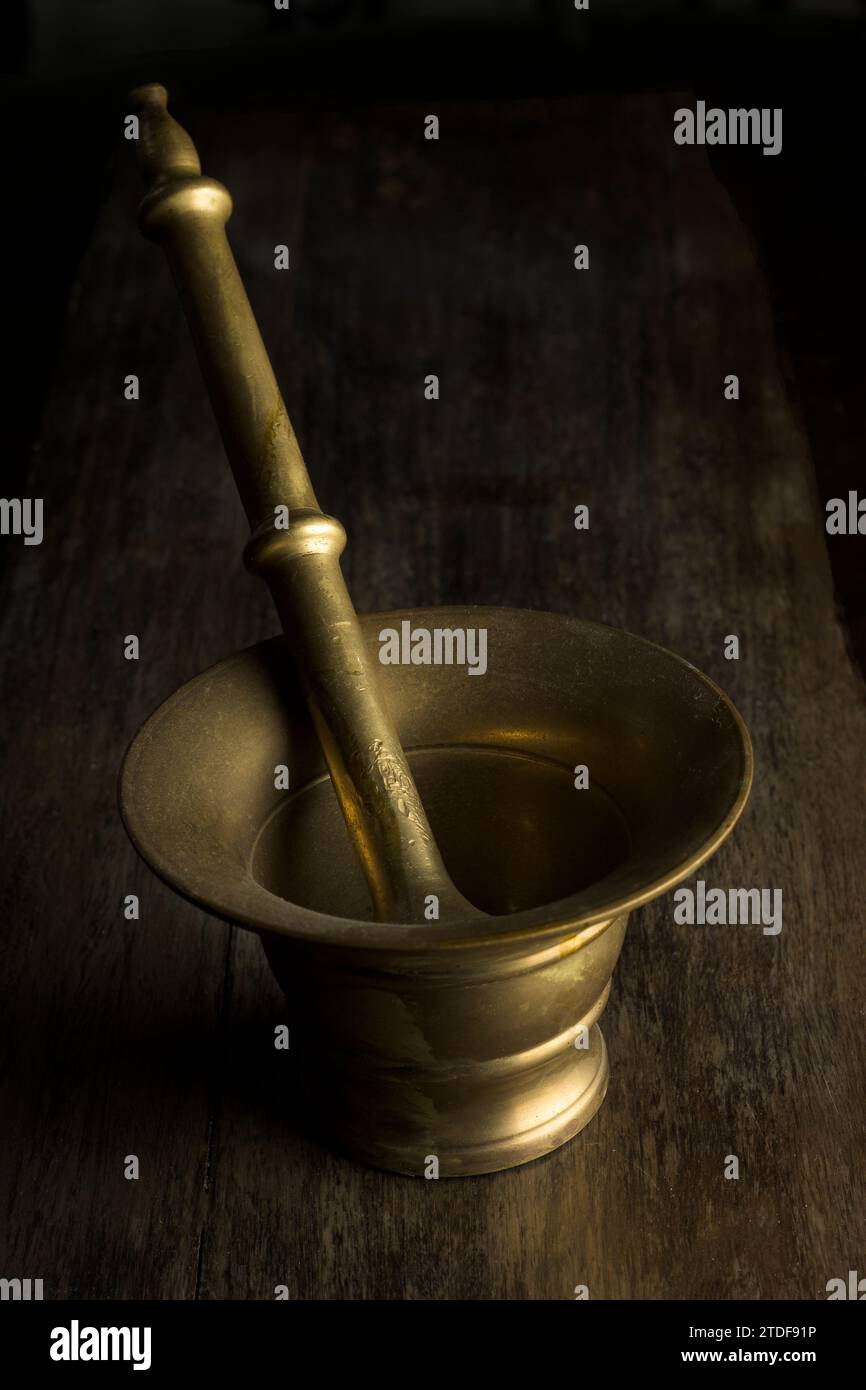 Copper mortar pestle with vertical handle with dark background kitchen ...