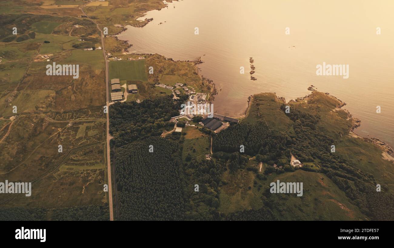Top down whiskey distillery at sunset seascape. Aerial nobody nature ...