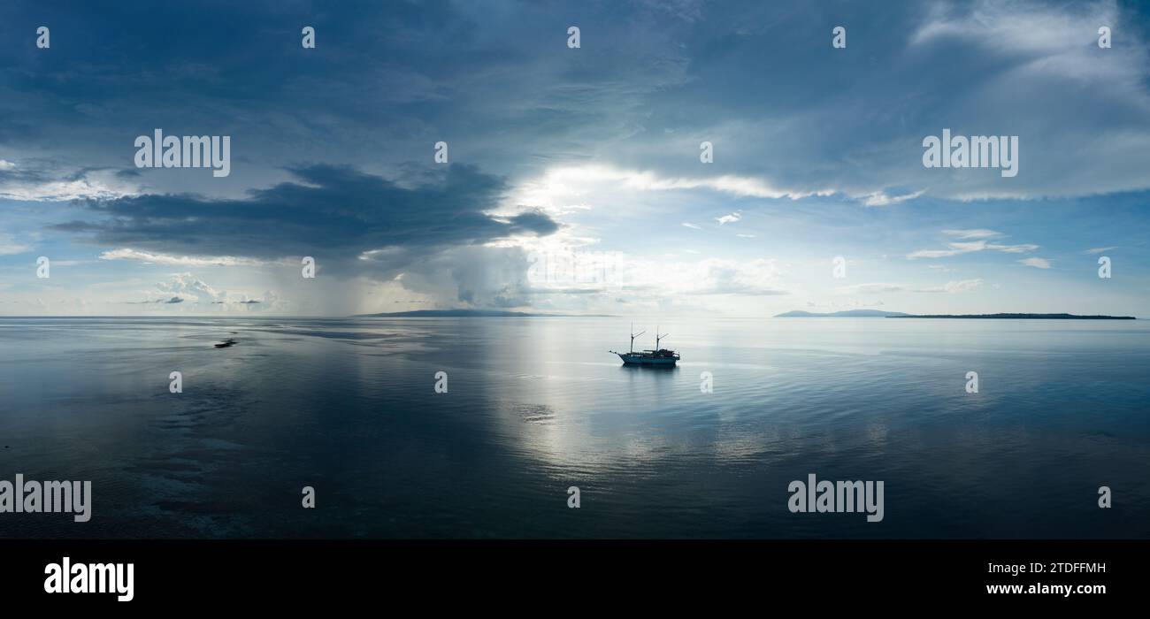 Morning light illuminates a phinisi schooner in Indonesia. This region ...
