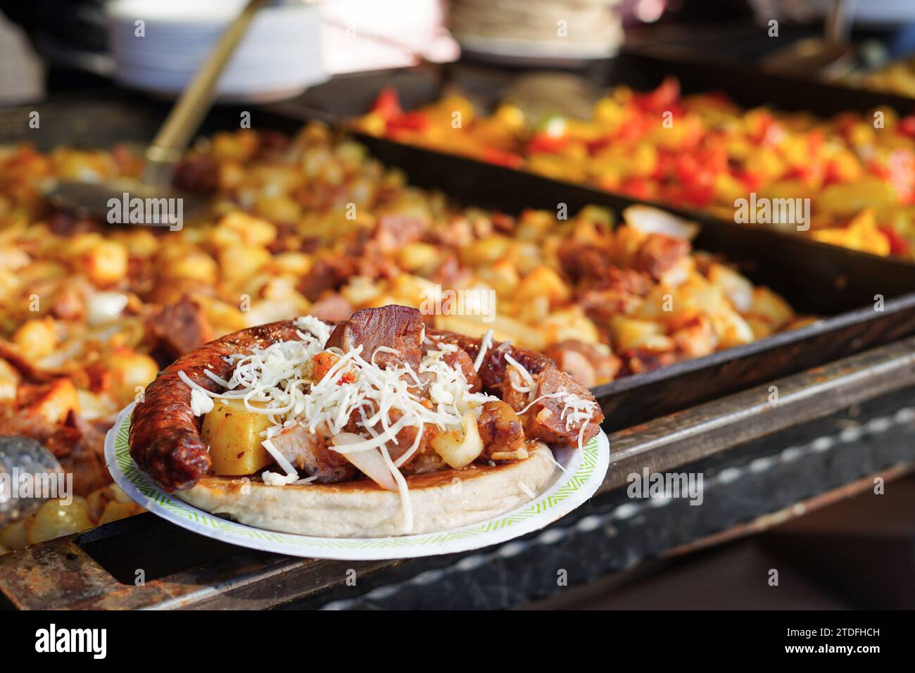 bbq street food, meat with onions on a plate, selling food at a fair ...
