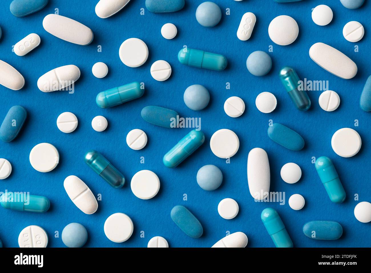 Blue and white pills and tablets against blue background Stock Photo ...