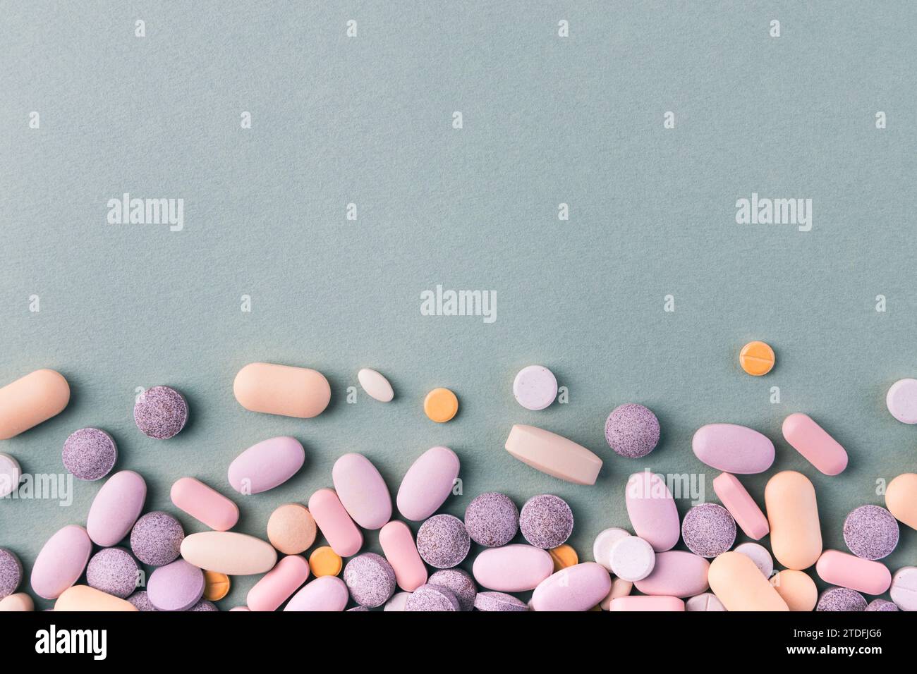 Pastel coloured pills and tablets against pale green backround Stock ...