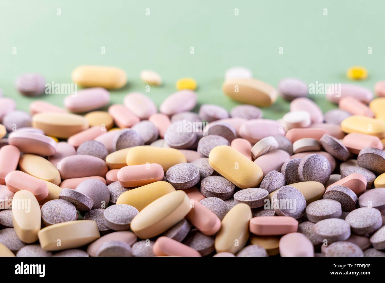 Pastel coloured pills and tablets background Stock Photo - Alamy