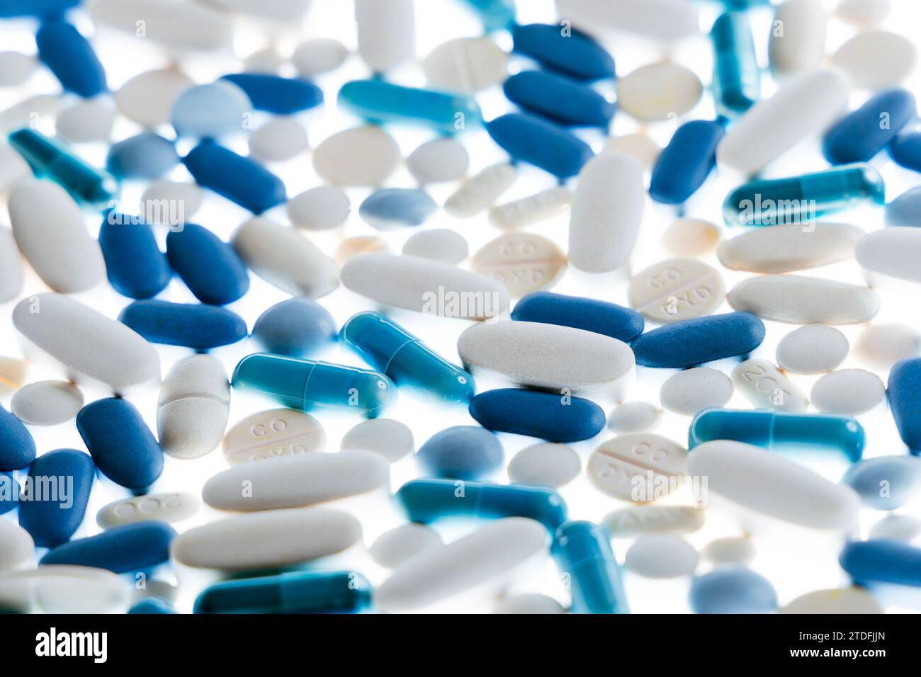 Blue and white pills and tablets Stock Photo - Alamy